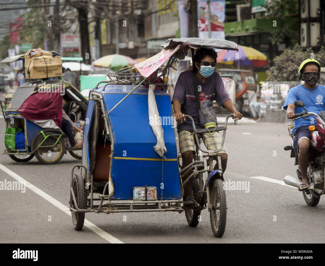 Ligao, Albay, Philippines. 24th Jan, 2018. A pedicab driver wearing a ...