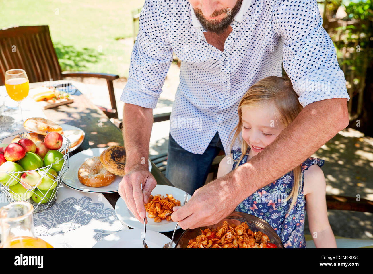 Parents dishing up pasta hi-res stock photography and images - Alamy