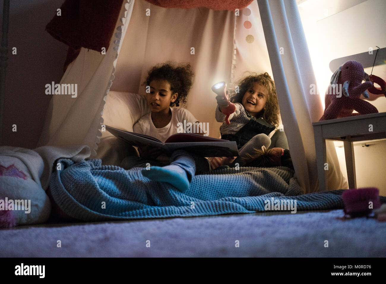 Children reading by torch hi-res stock photography and images - Alamy