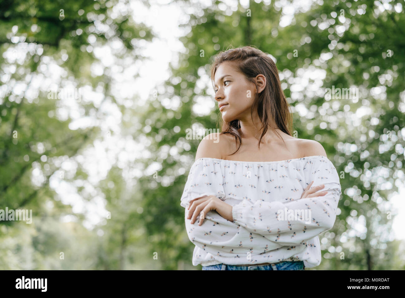 Portrait of young woman in a park Stock Photo - Alamy