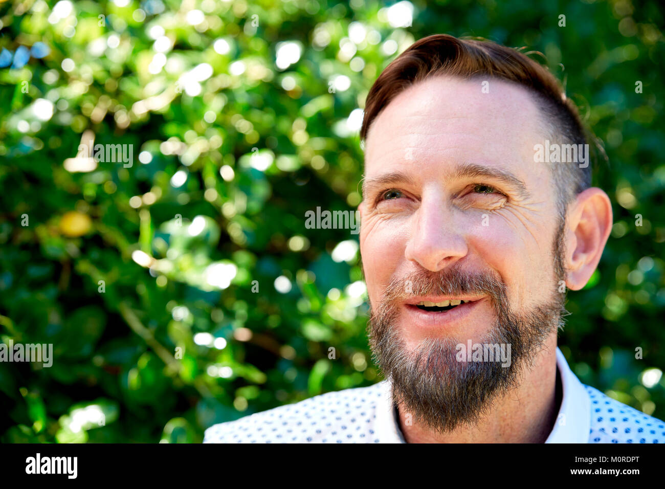 Portrait of smiling bearded man outdoors Stock Photo - Alamy