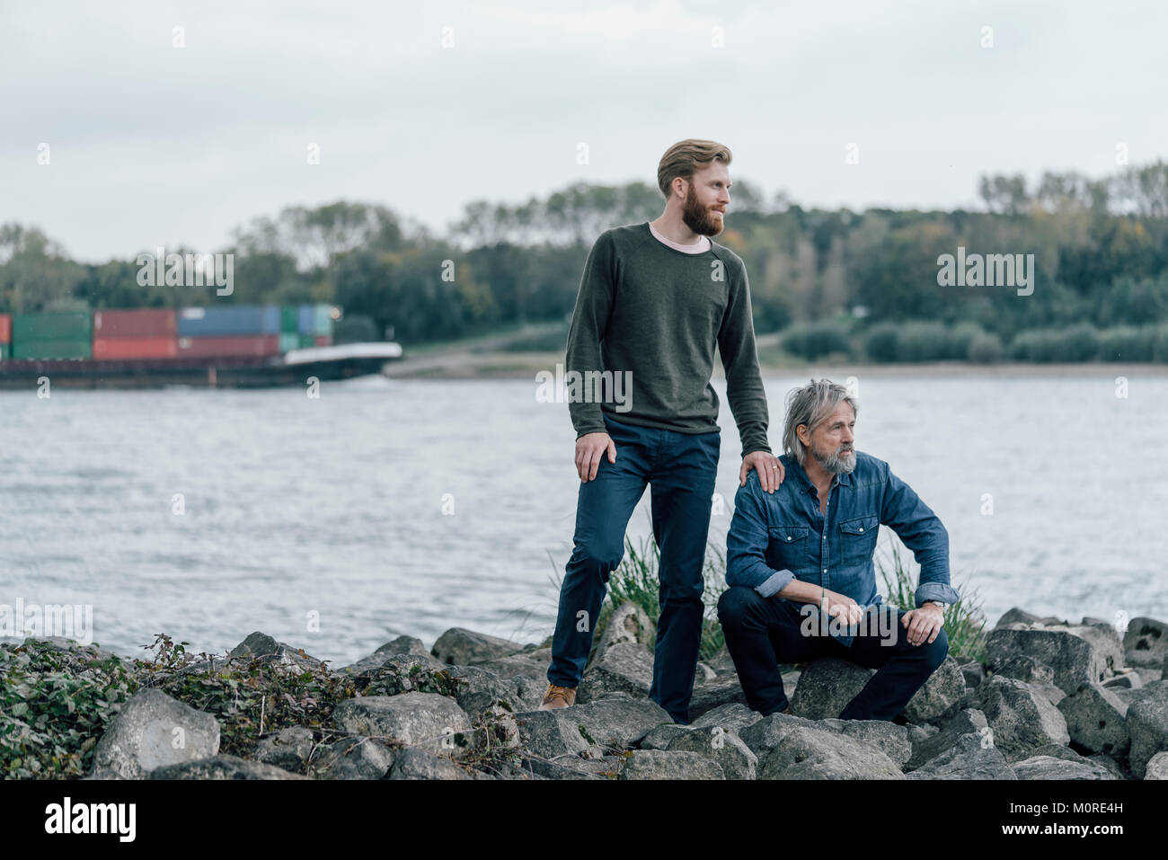 Father and son spending time together outdoors, taking a break, sitting ...