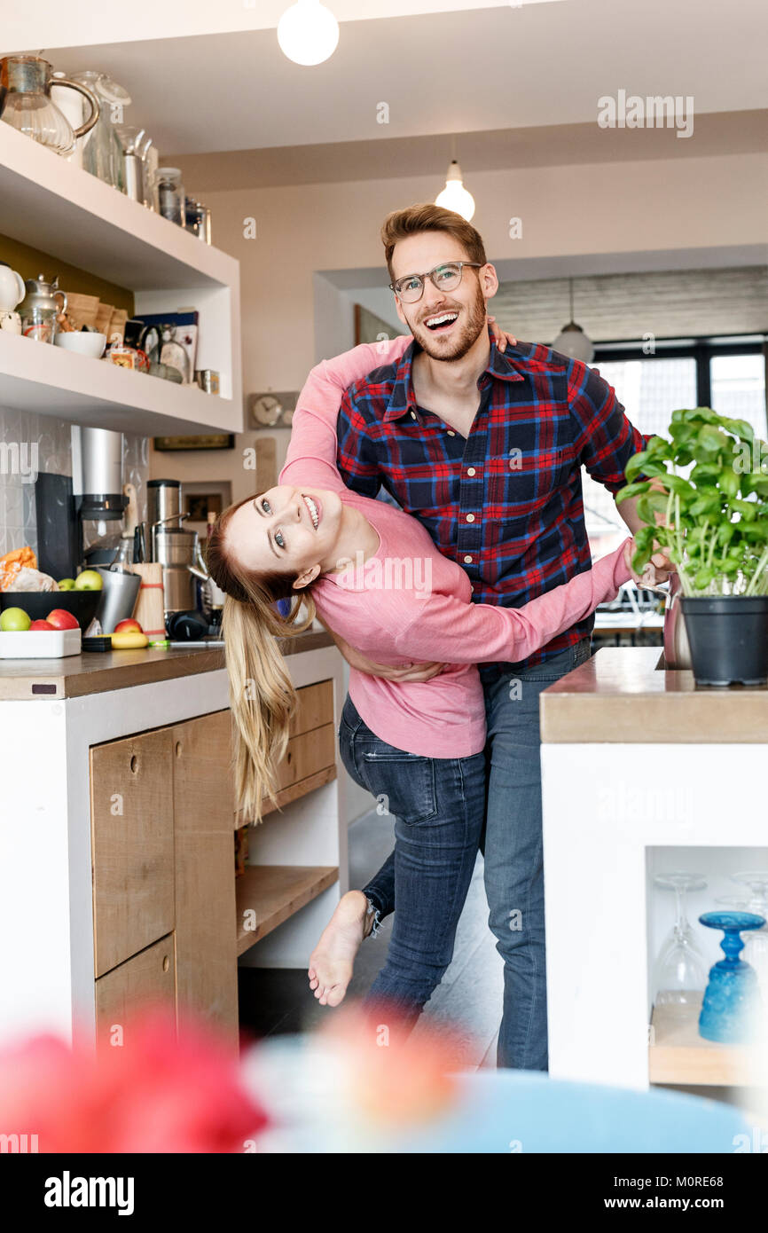 Happy young couple dancing in the kitchen Stock Photo - Alamy