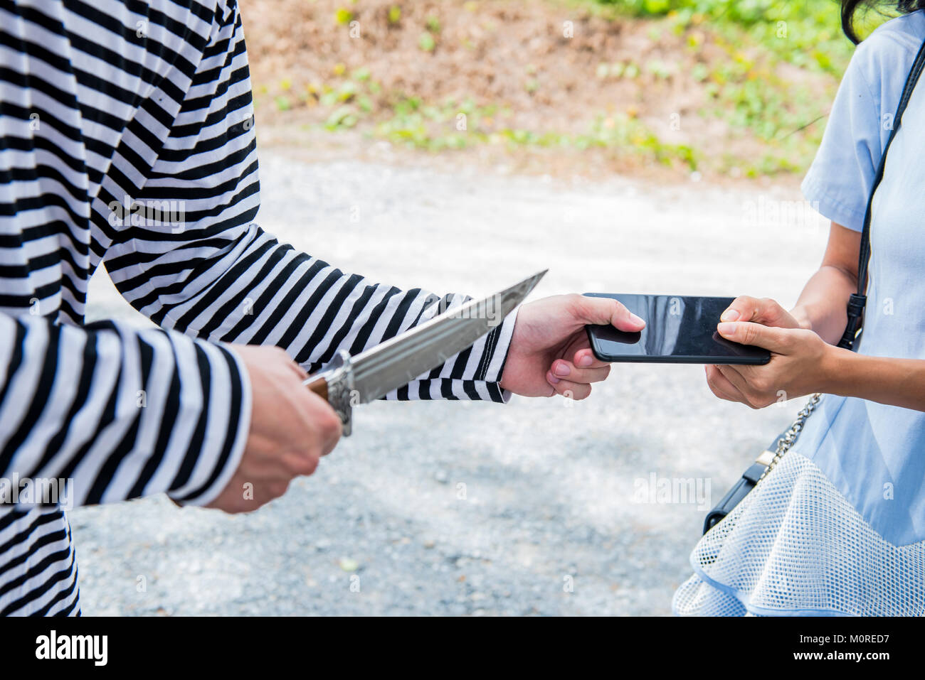 Thief is trying to steal at the public place Stock Photo - Alamy