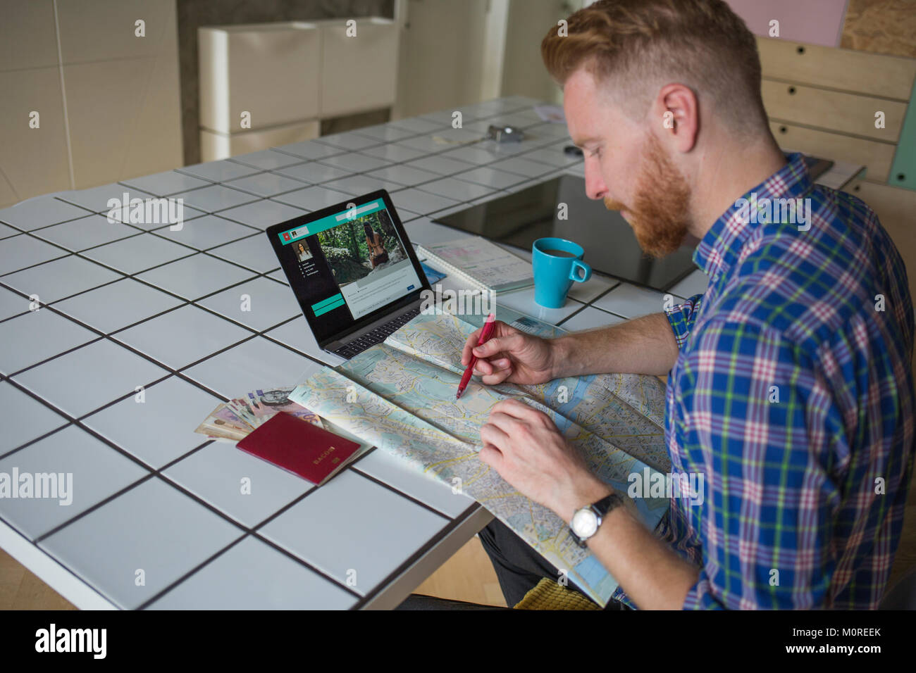 Man planning a trip at home Stock Photo - Alamy