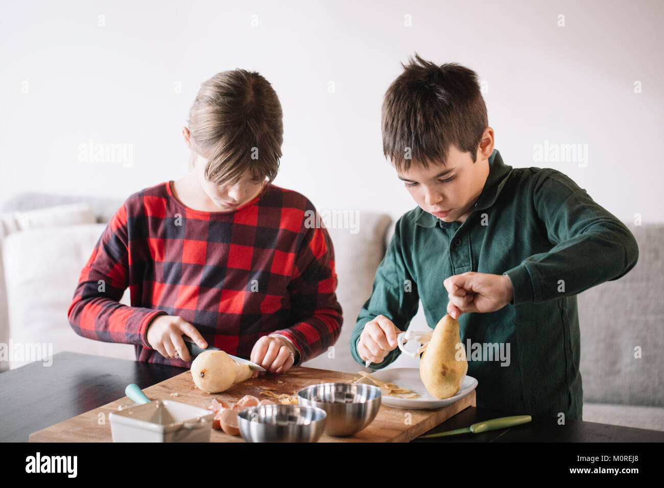 Girl and boy preparing pears Stock Photo - Alamy