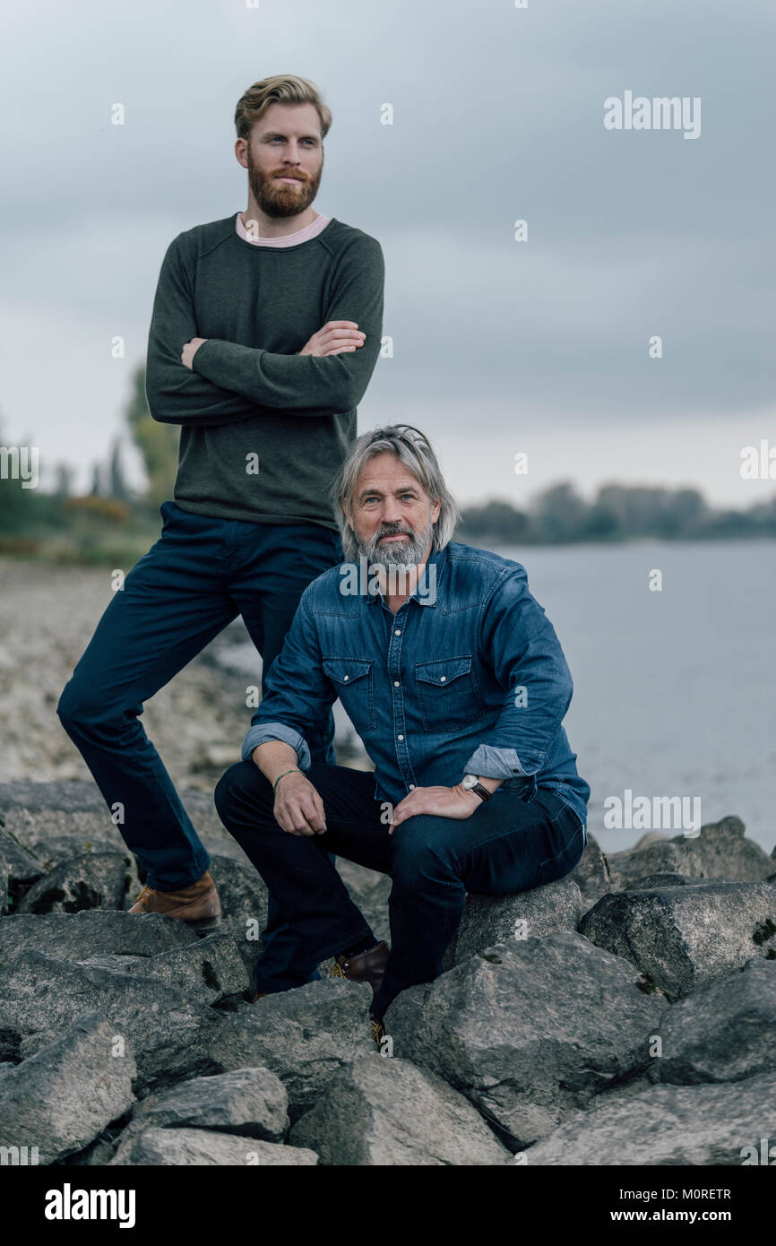 Father and son spending time together outdoors, taking a break, sitting ...