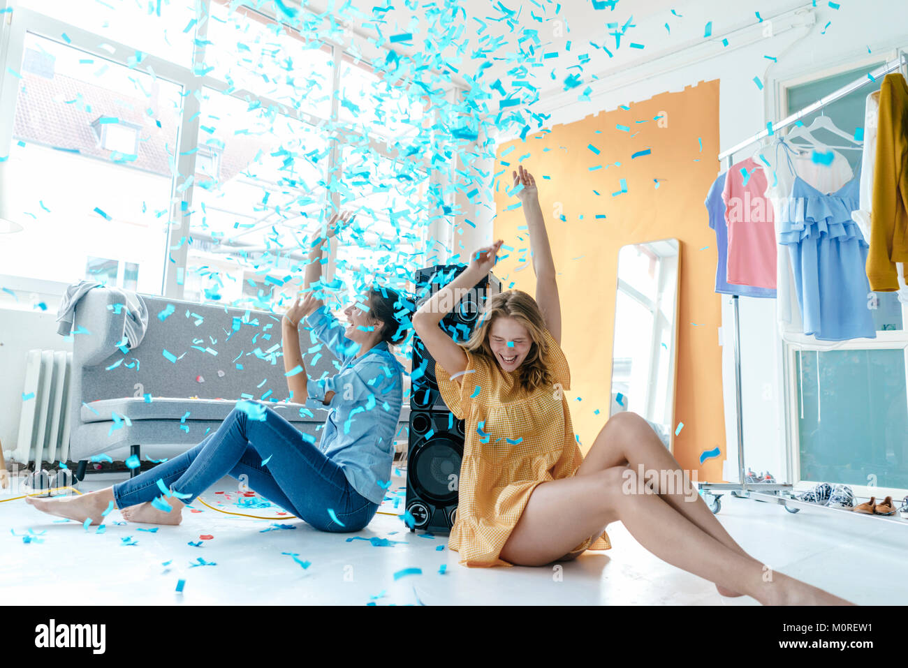 Two excited young women having a party Stock Photo - Alamy