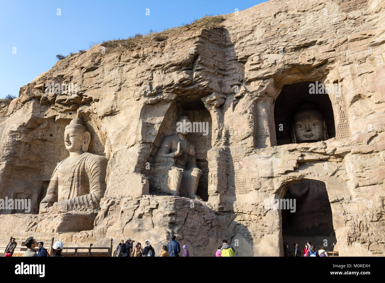 November 2014 - Datong, China - Tourists exploring the Yungang Grottoes ...