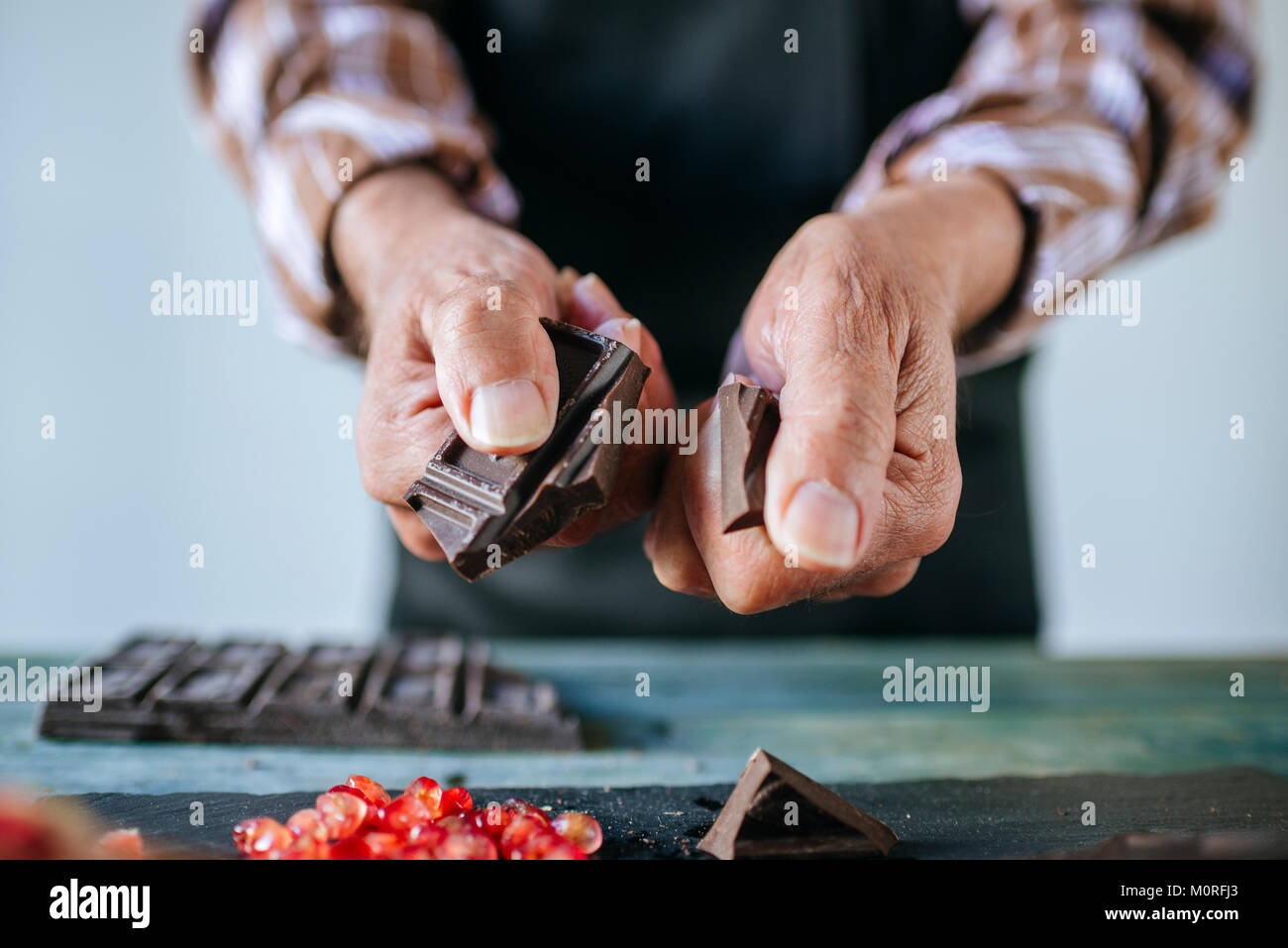 Hand breaking chocolate bar hi-res stock photography and images - Alamy
