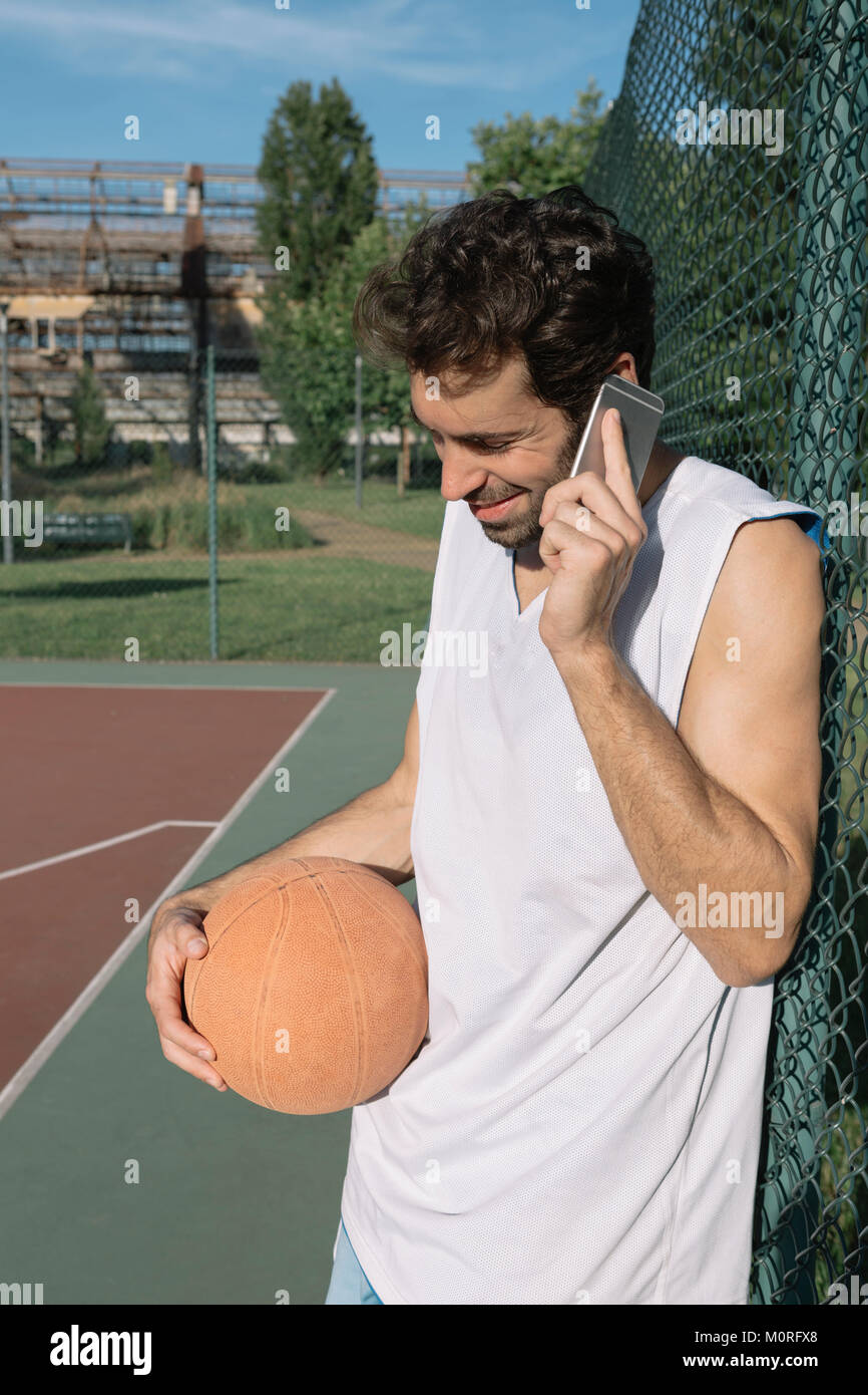 Basketball player on the phone Stock Photo - Alamy