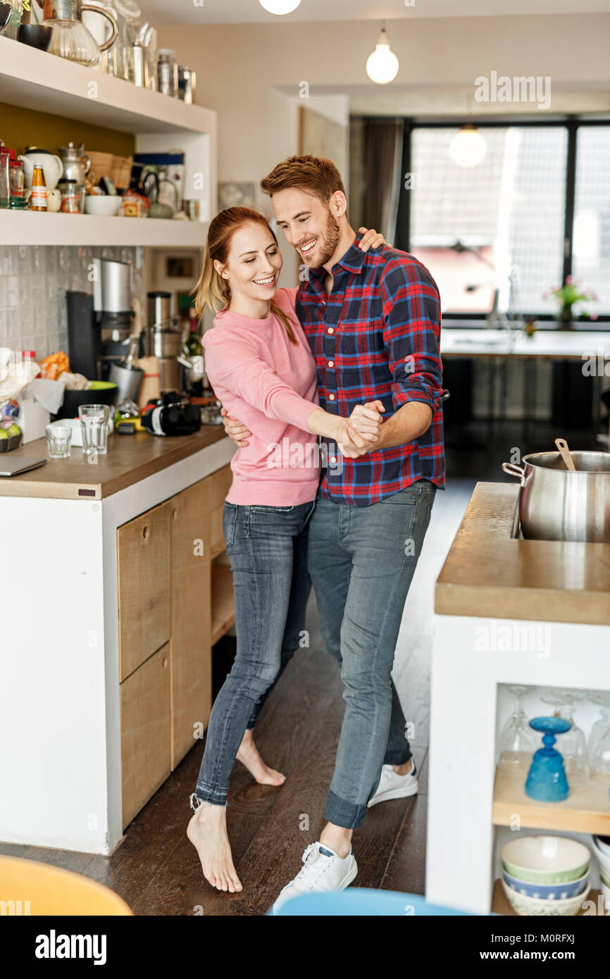 Happy young couple dancing in the kitchen Stock Photo - Alamy