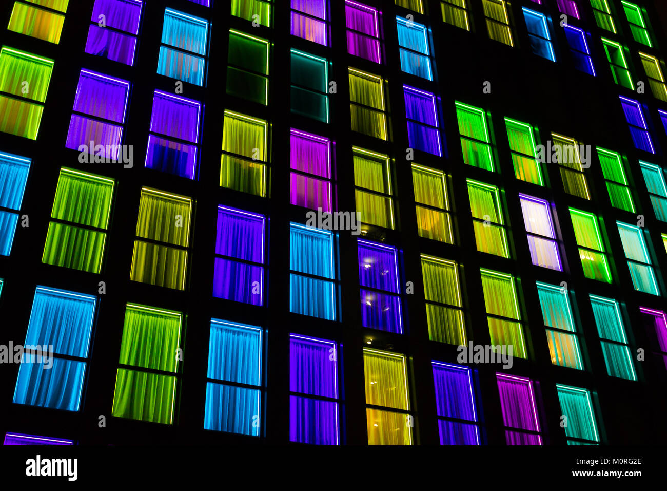Colored windows texture. Windows illuminated by neon lights background ...