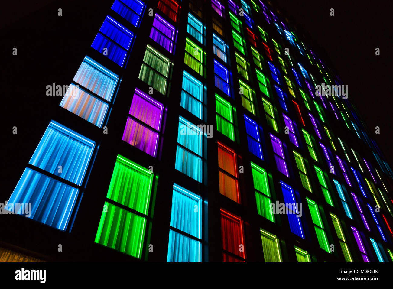Colored windows texture. Windows illuminated by neon lights background ...