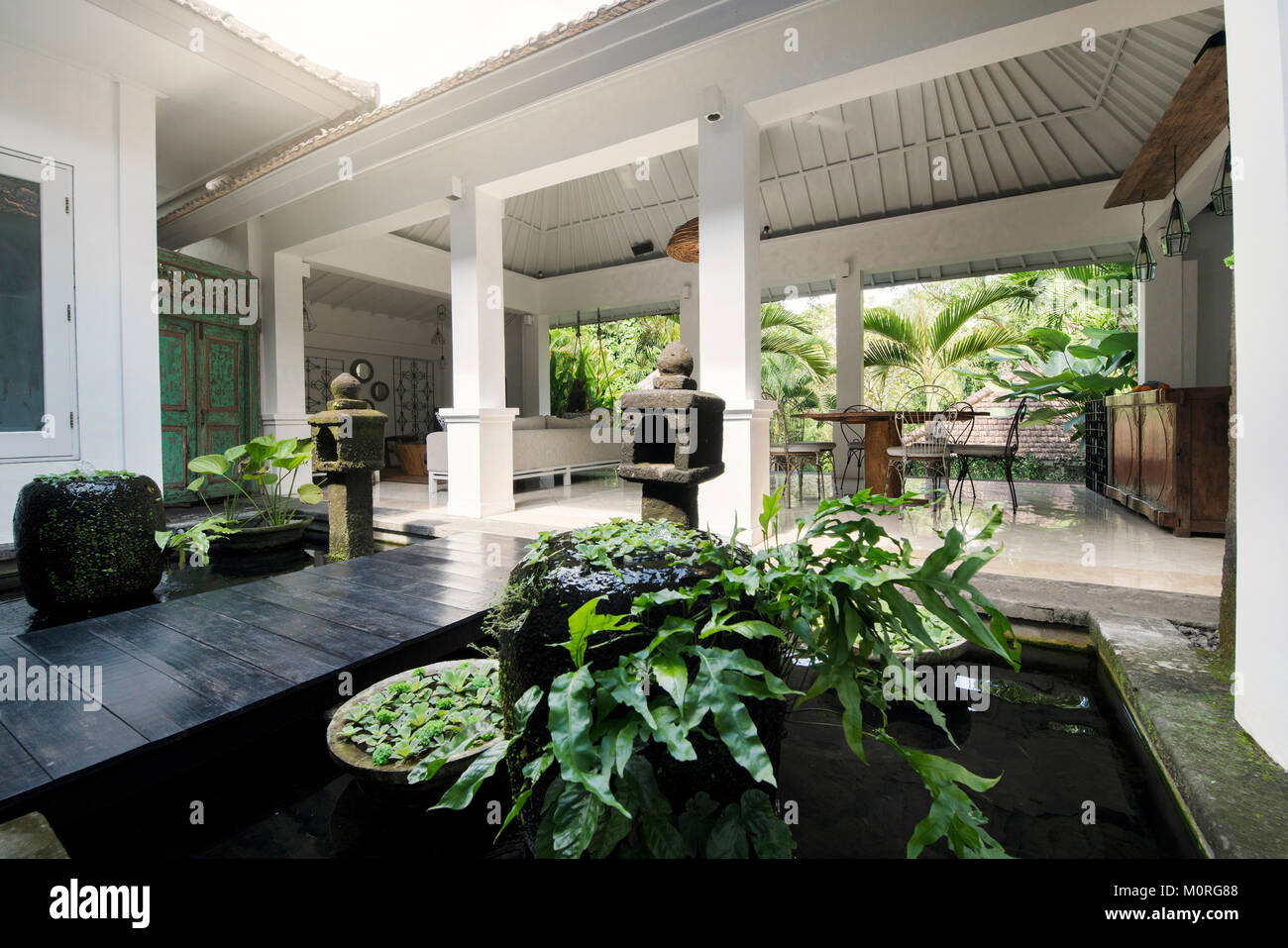 Atrium and open living area in tropical home Stock Photo - Alamy