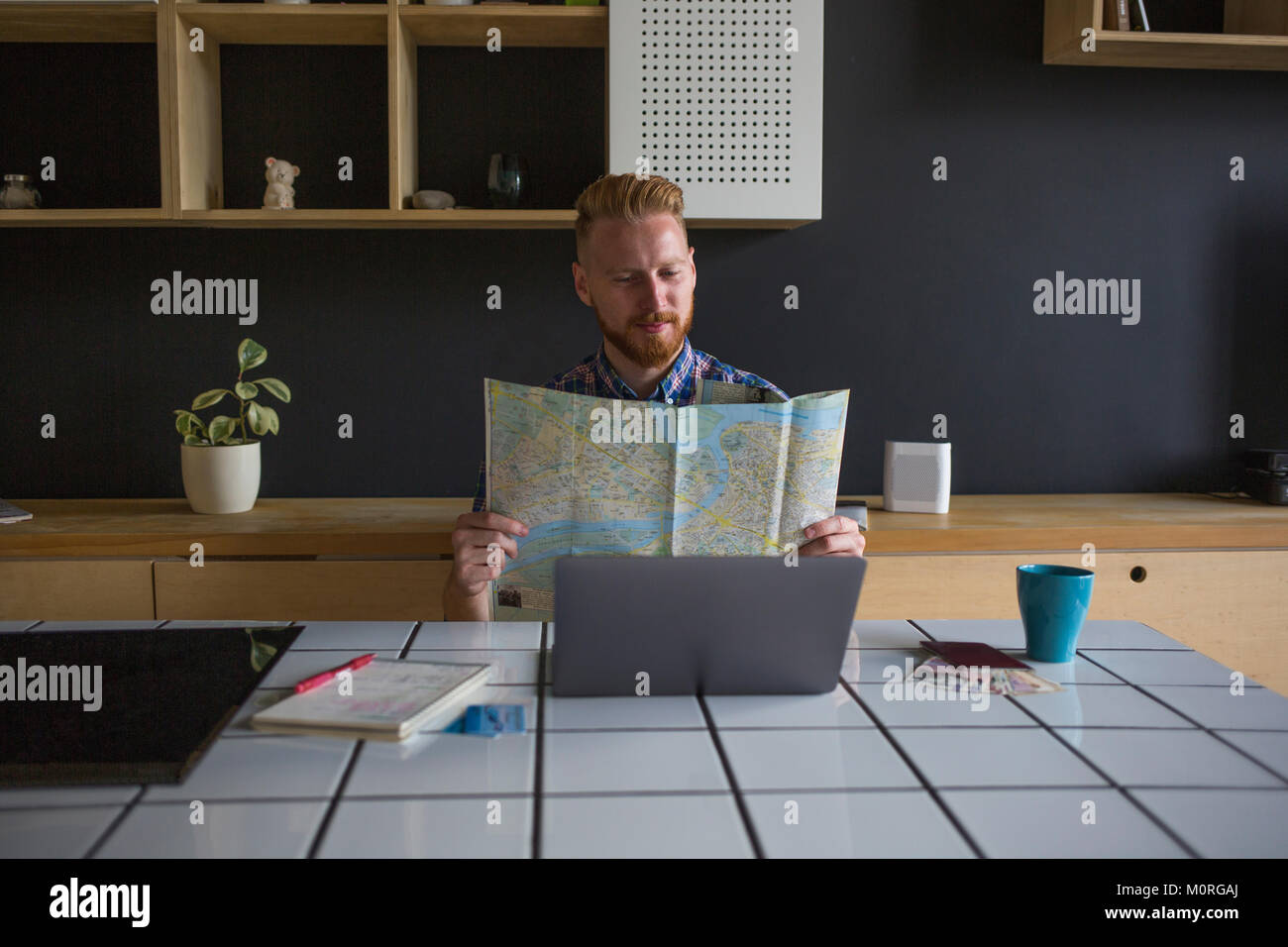 Man planning a trip at home Stock Photo - Alamy