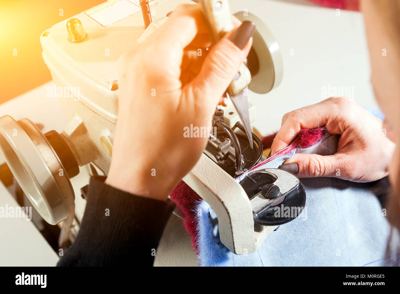 Sewing machine for stitching of fur skins fur coat Stock Photo - Alamy