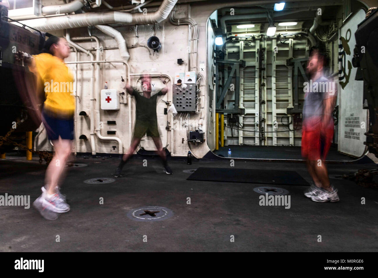 INDIAN OCEAN (Dec. 29, 2017) Sailors and Marines perform jumping jacks ...