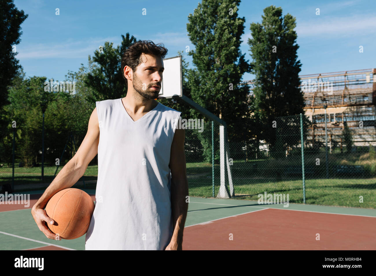 Man with basketball on basketball ground Stock Photo - Alamy
