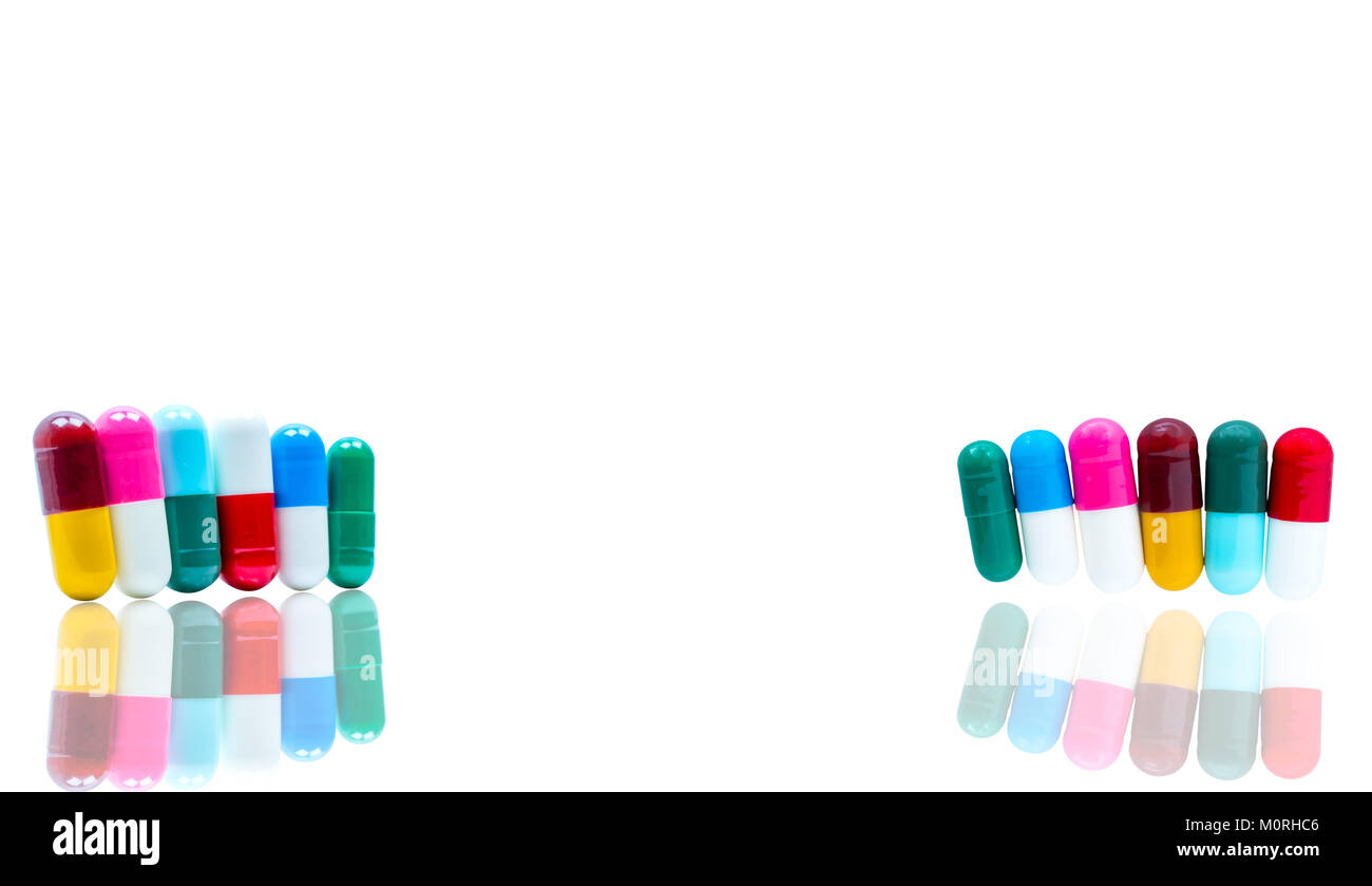 Antibiotic capsules pills in a row on white background with shadows and ...