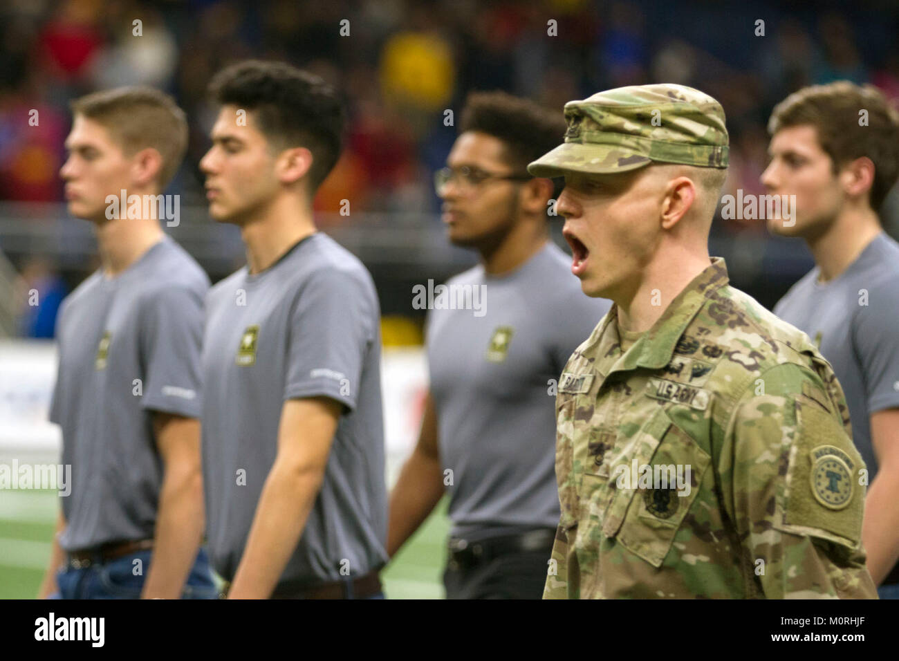 A U.S. Army Soldier marches recruits onto the football field at the ...