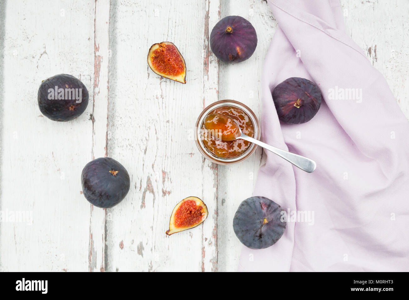 Organic figs and a glass of fig jam on a wood Stock Photo - Alamy