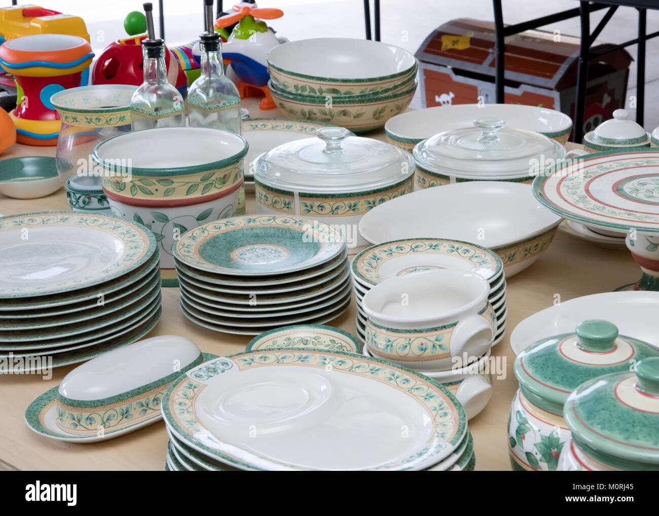 Collection of matching dishes and toys for sale at a garage sale Stock ...