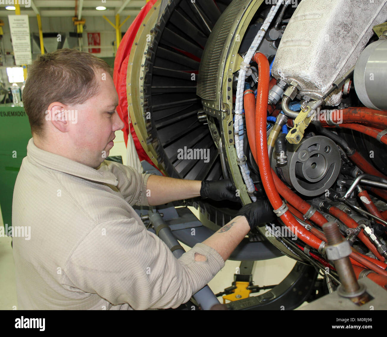 Airman 1st Class Johnny Bowen works on a TF34 jet engine from an A-10 ...