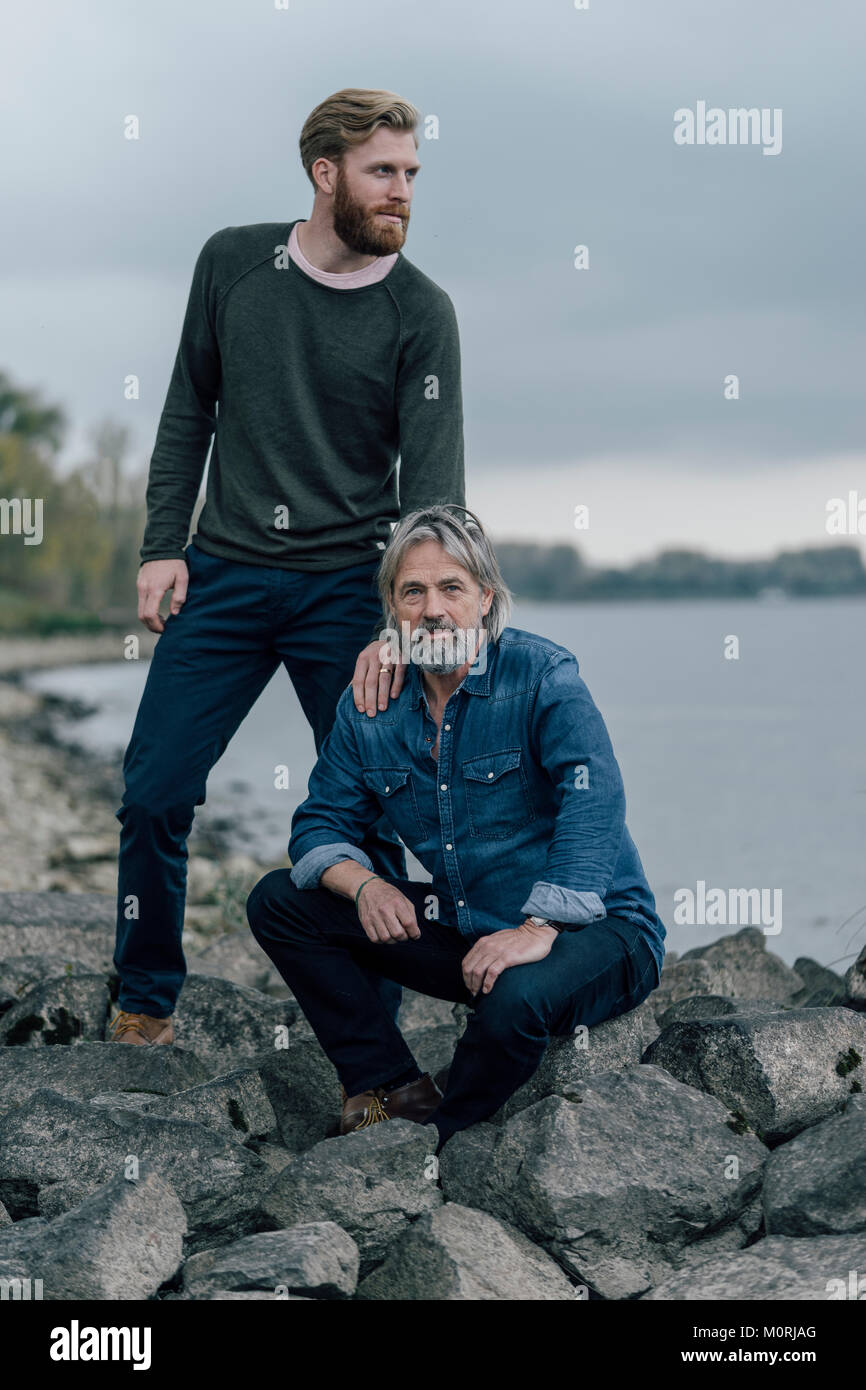 Father and son spending time together outdoors, taking a break, sitting ...