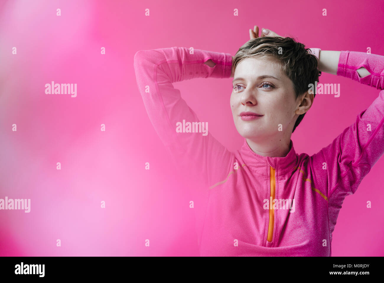 Portrait of woman in pink sportswear Stock Photo - Alamy