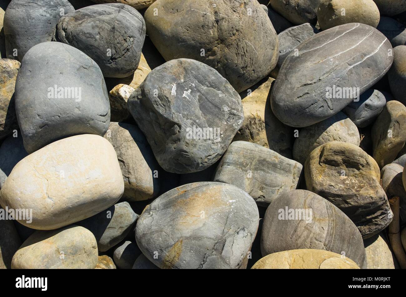 boulders and colorful pebbles on the beach on a warm summer day Stock ...