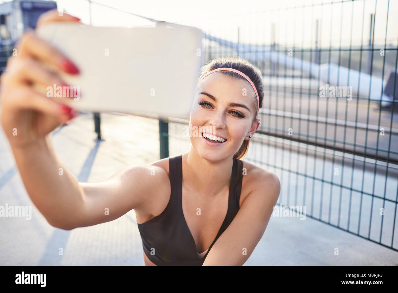 Fit woman taking selfie after outdoor workout Stock Photo - Alamy