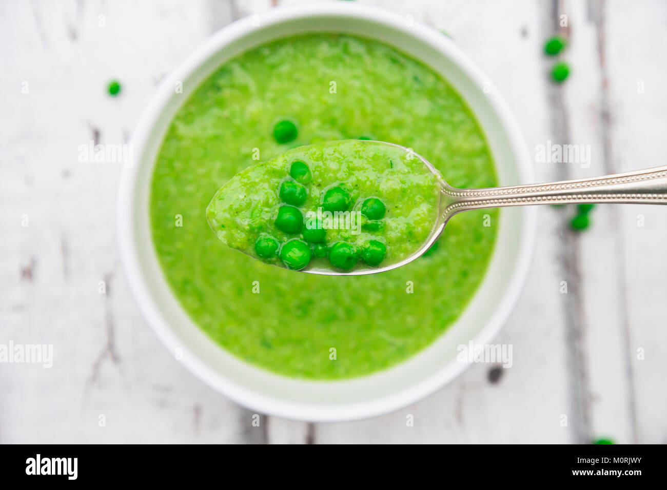 Spoon of pea soup and peas Stock Photo - Alamy