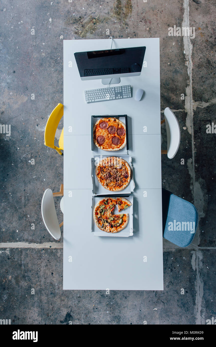 Meeting table with pizza and pc Stock Photo - Alamy