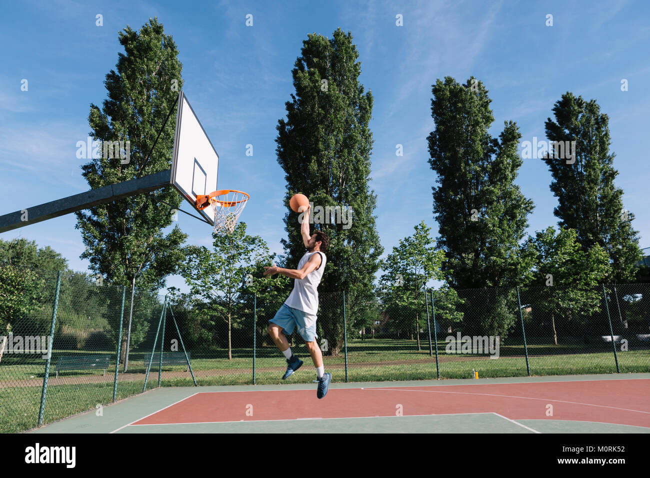 Man playing basketball Stock Photo - Alamy