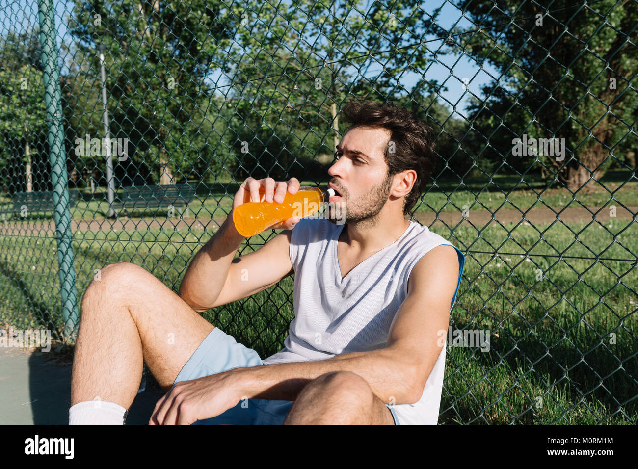 Basketball player drinking from bottle Stock Photo - Alamy