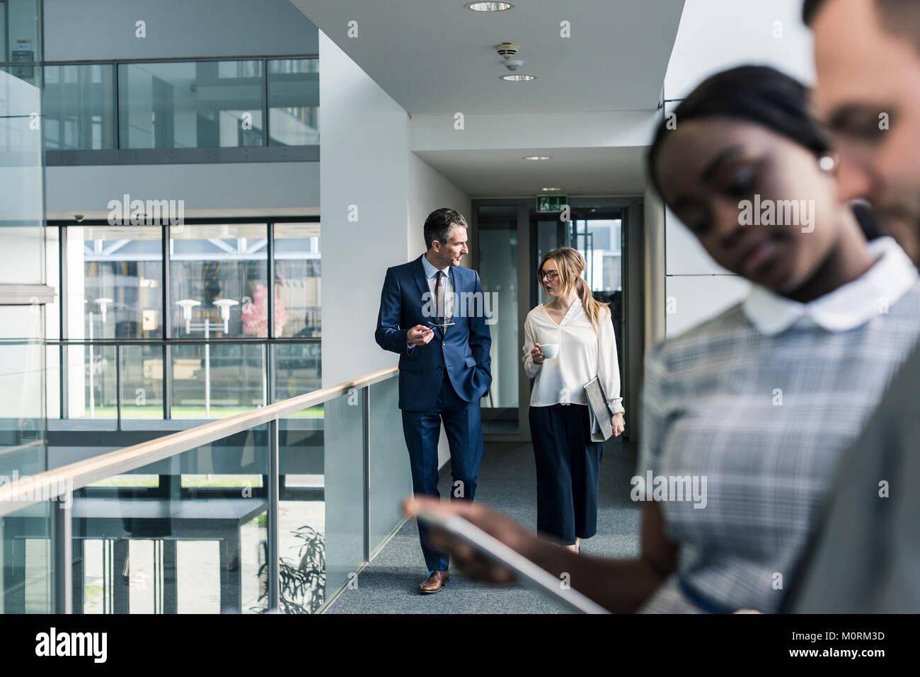 Business people talking on office floor Stock Photo - Alamy