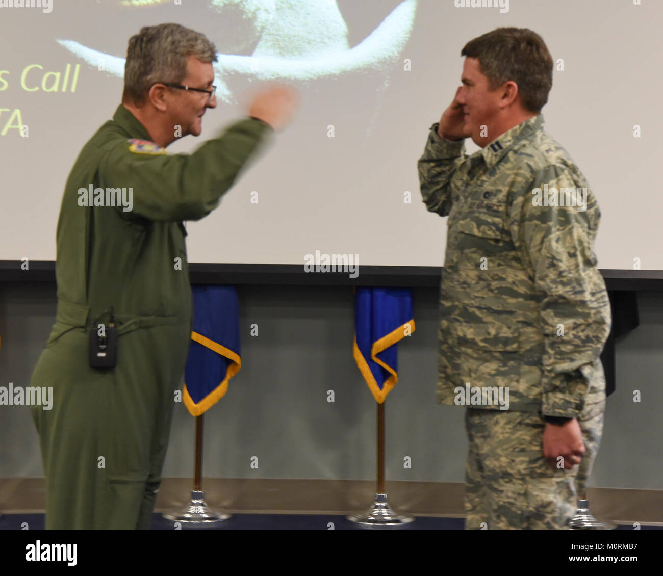 Capt. Jeffrey Farmer, 117th Civil Engineering Squadron recieves a coin ...
