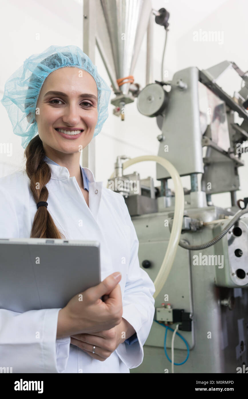 Portrait of quality control inspector smiling during inspection Stock ...
