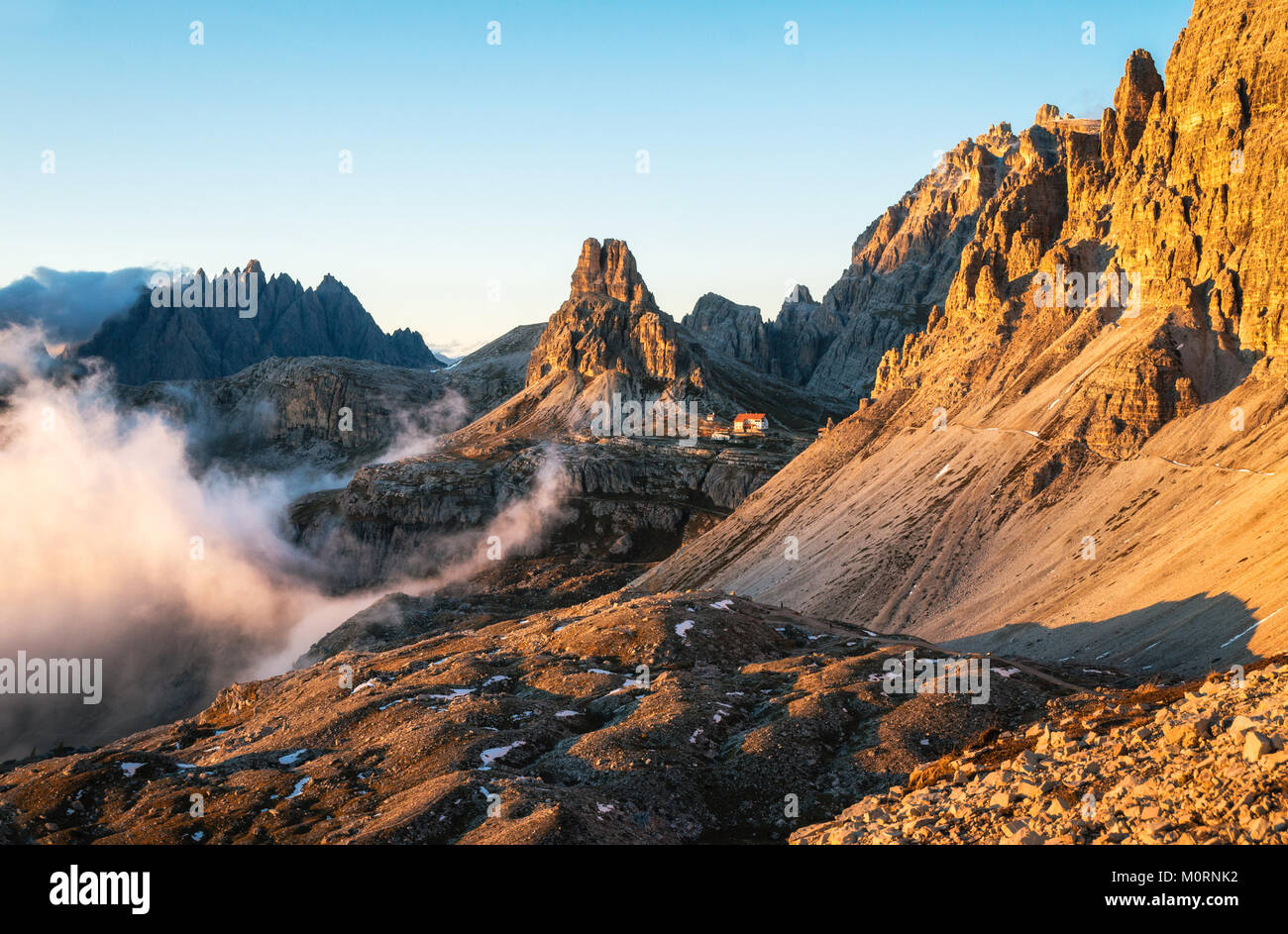 Dolomites Alps rocky mountain range and Rifugio Locatelli at sunset ...