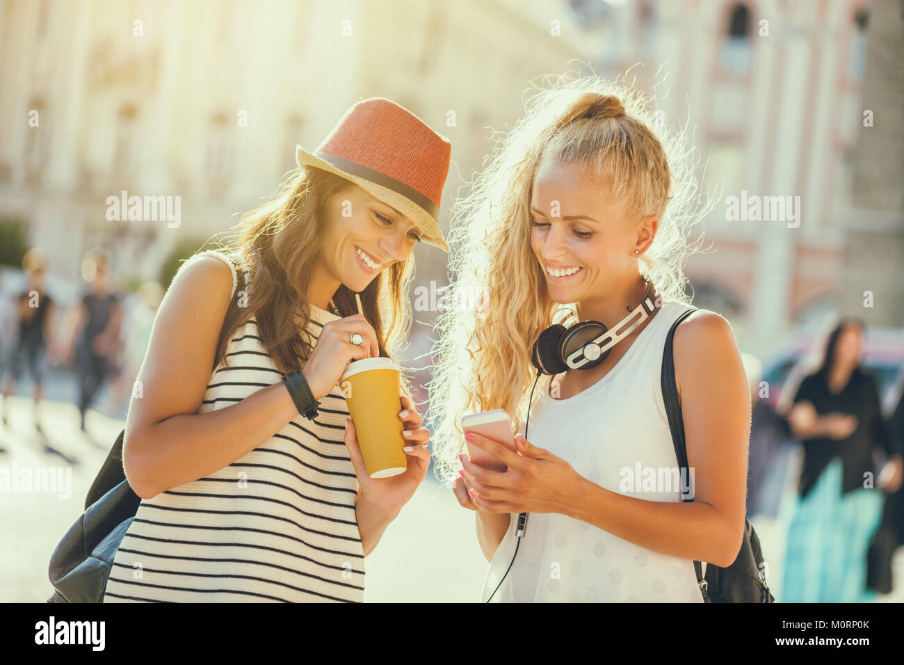 Two happy women are having nice time together in the city Stock Photo ...
