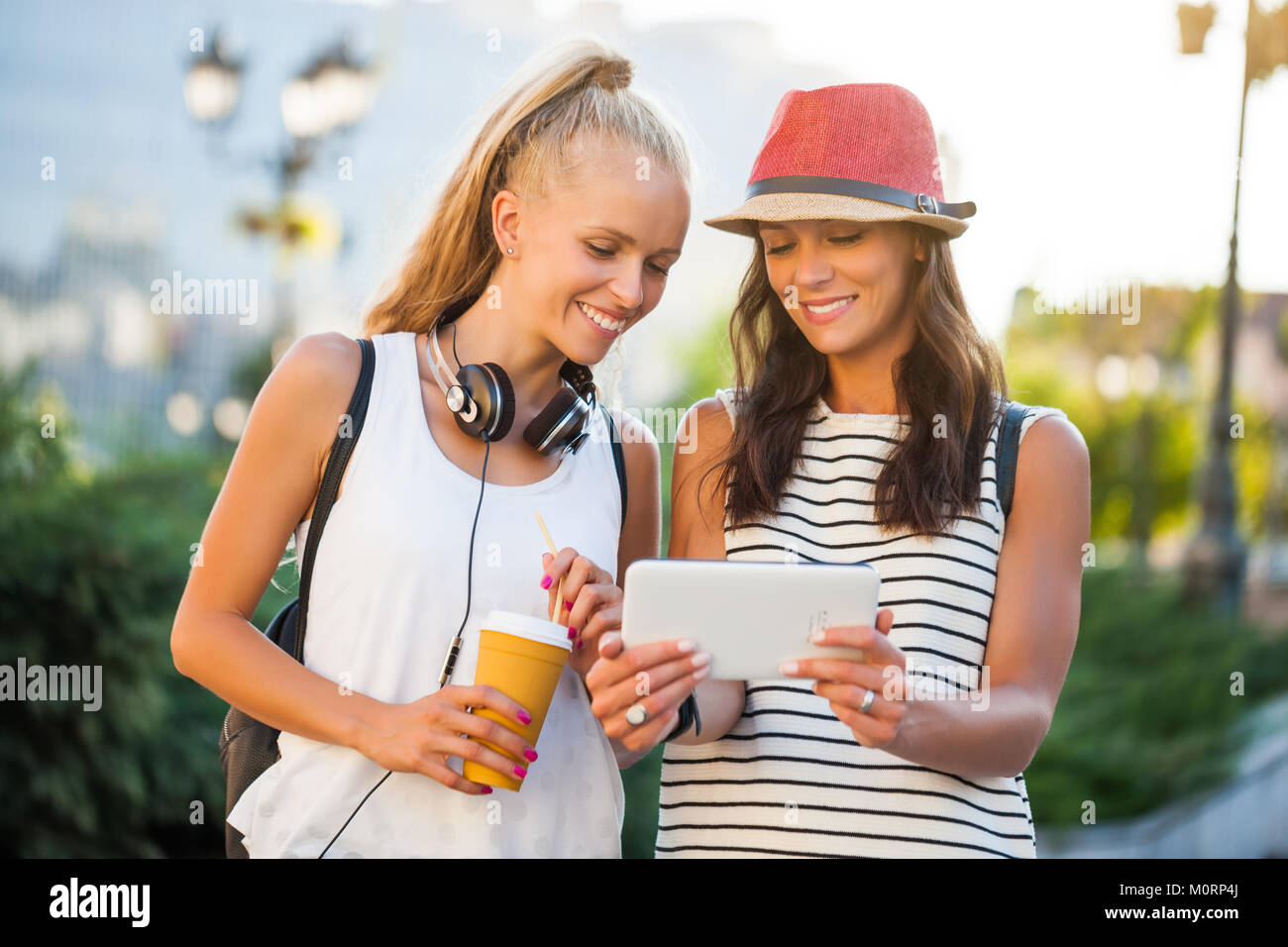 Two happy women are having nice time together in the city Stock Photo ...