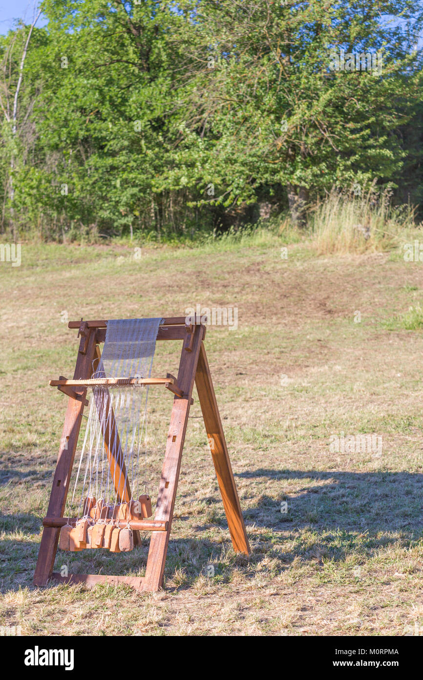 Antique weaving loom with hanging stones on the wires Stock Photo - Alamy