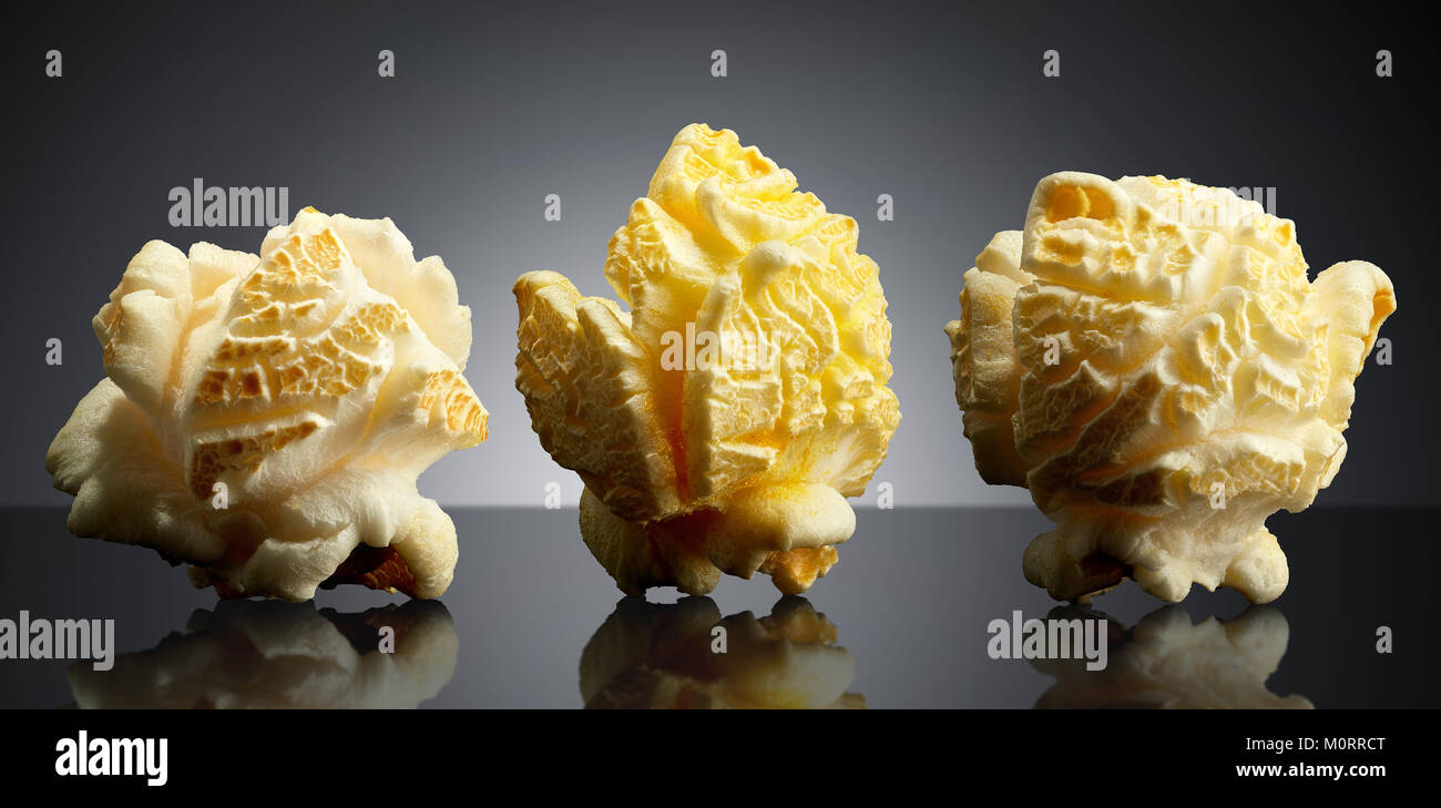 Group of popped popcorn on a black background Stock Photo - Alamy