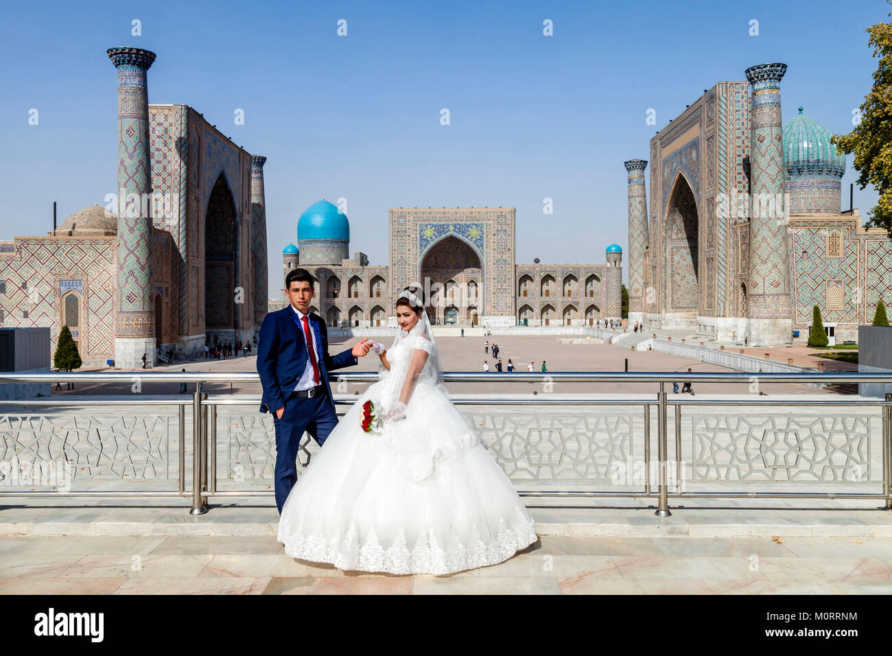 A Young Couple Pose For Their Wedding Photos At The Registan Complex ...