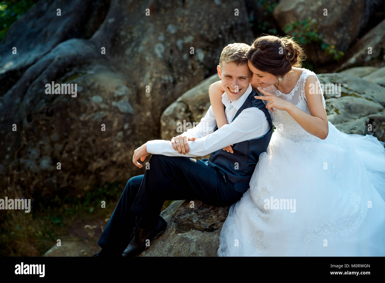Above outdoor wedding portrait of the charming brude hugging back the ...