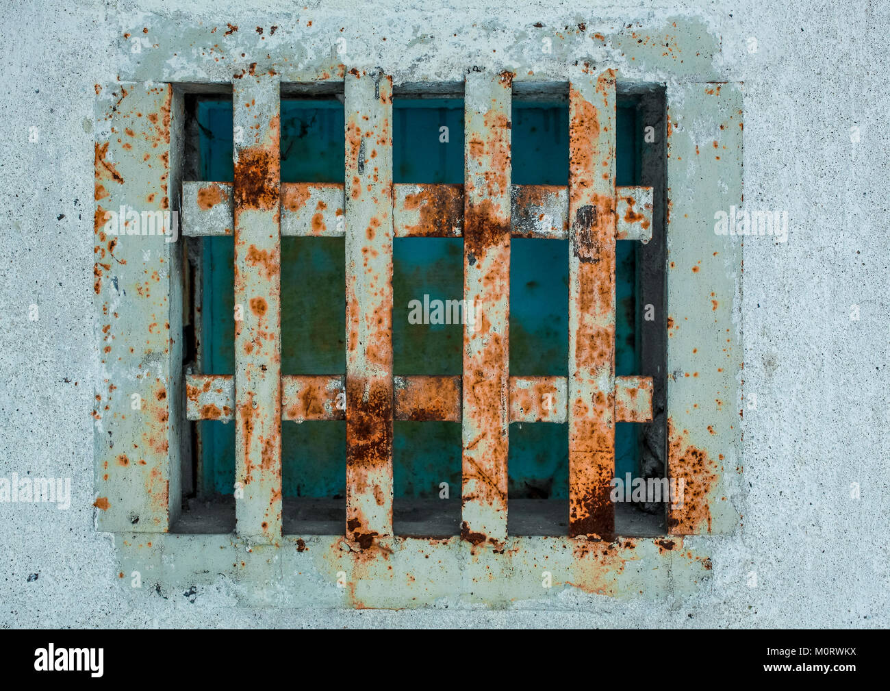 The concrete wall is a window, closed the old rusty grate Stock Photo ...