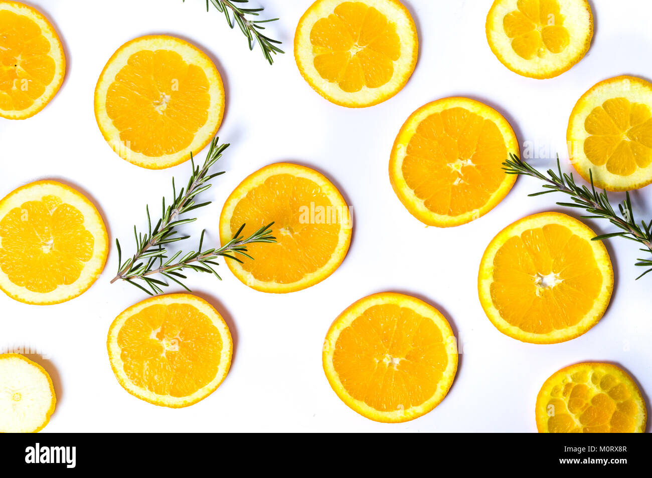 Sliced oranges with rosemary background pattern isolated flay lay Stock ...