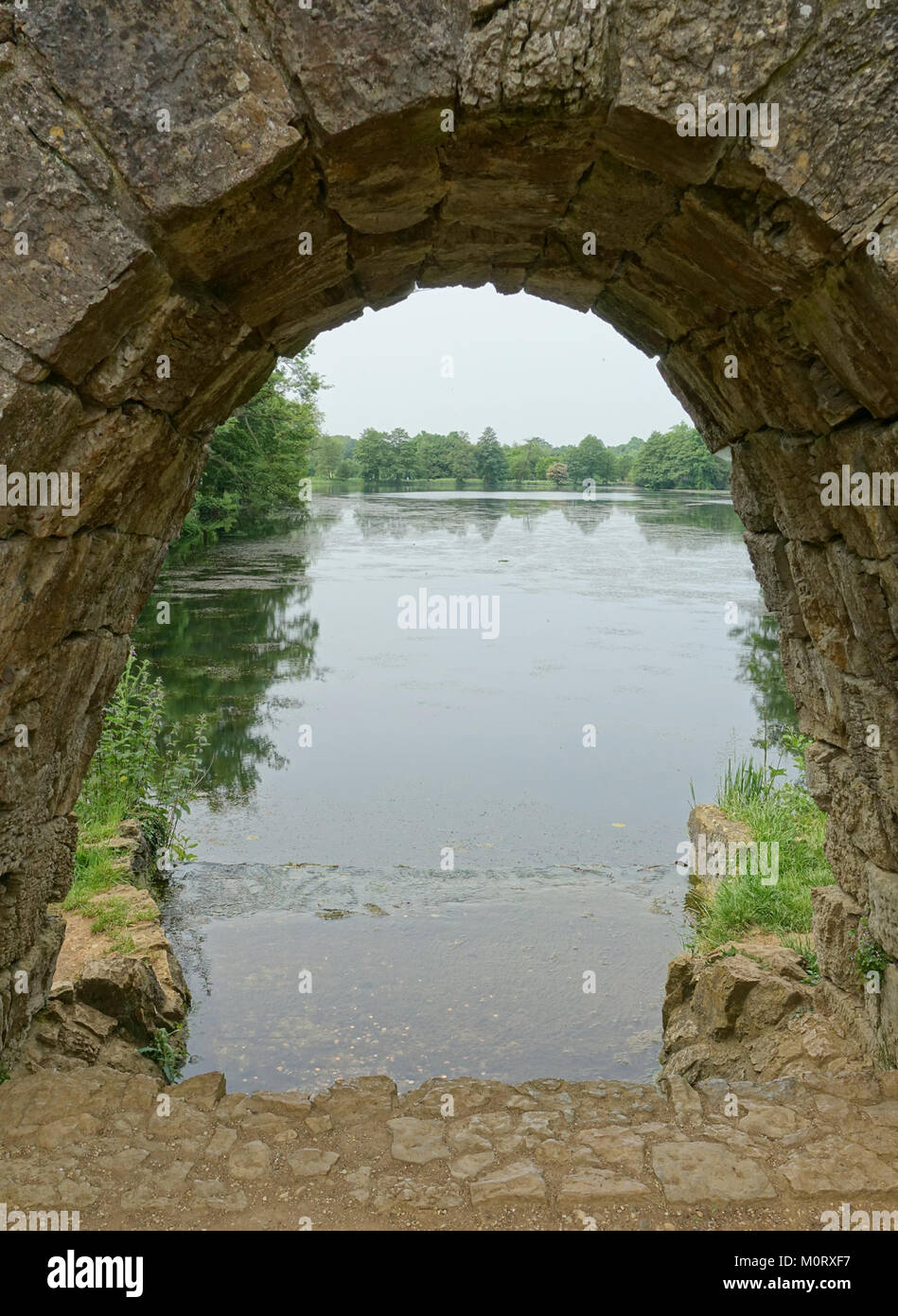 A scenic view of the Cascade and artificial ruins at Stowe Gardens in ...