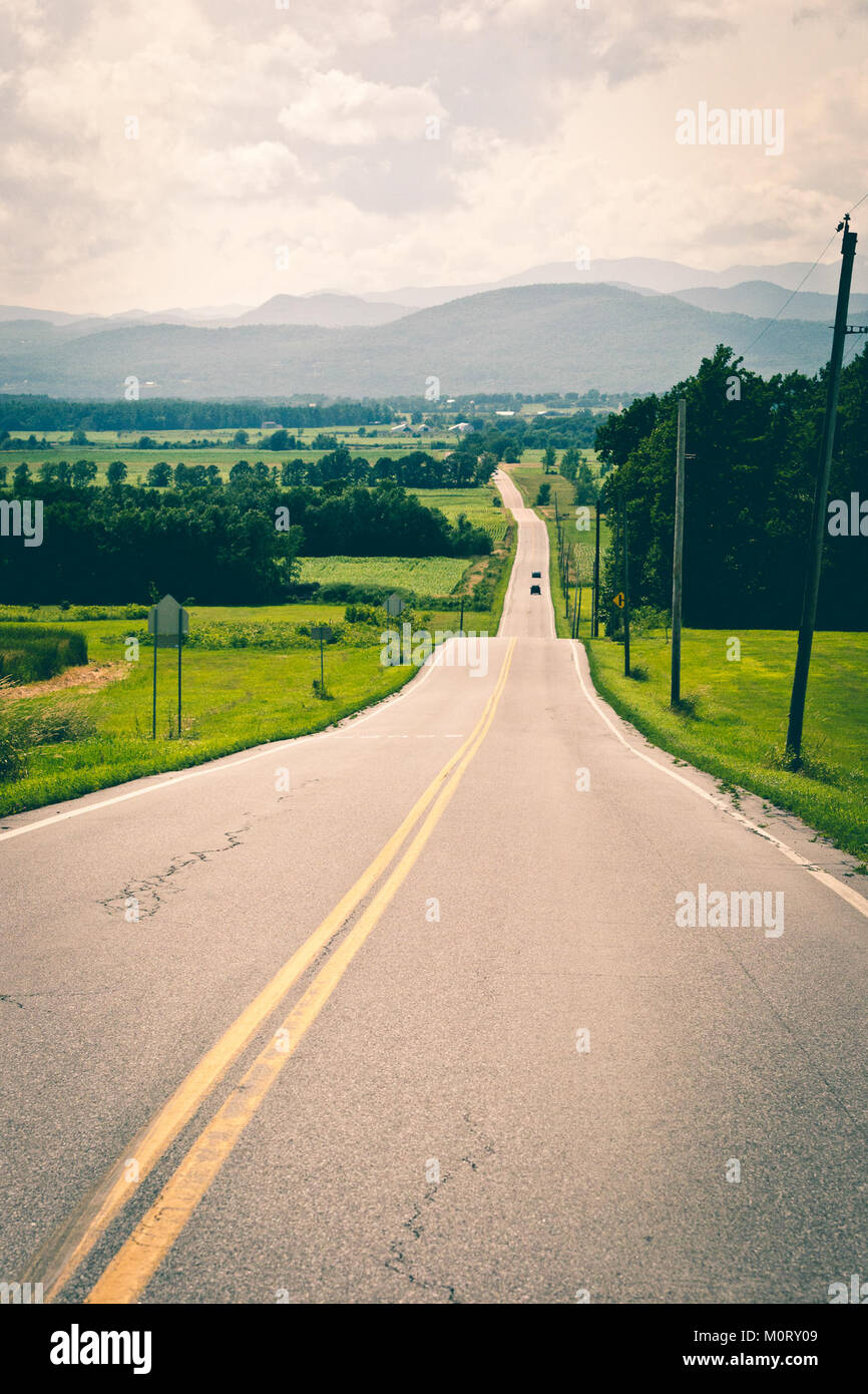 This image depicts a car driving on a mountainous road, highlighting ...